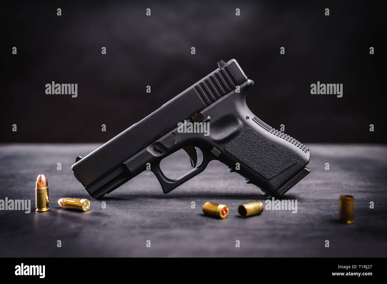black 9mm pistol on a black wooden table Stock Photo - Alamy