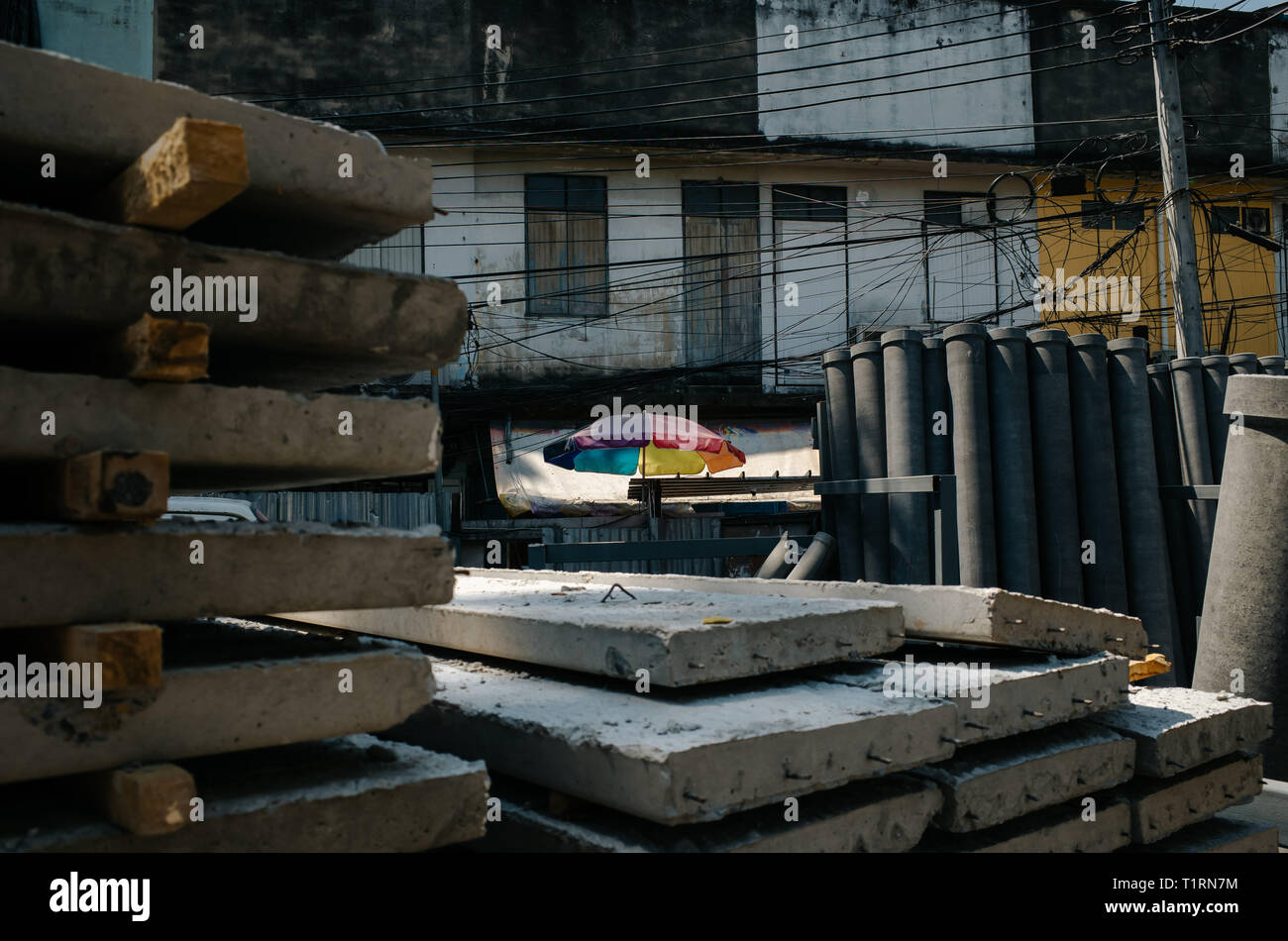 colorful umbrella amidst concrete construction material in Bangkok ...
