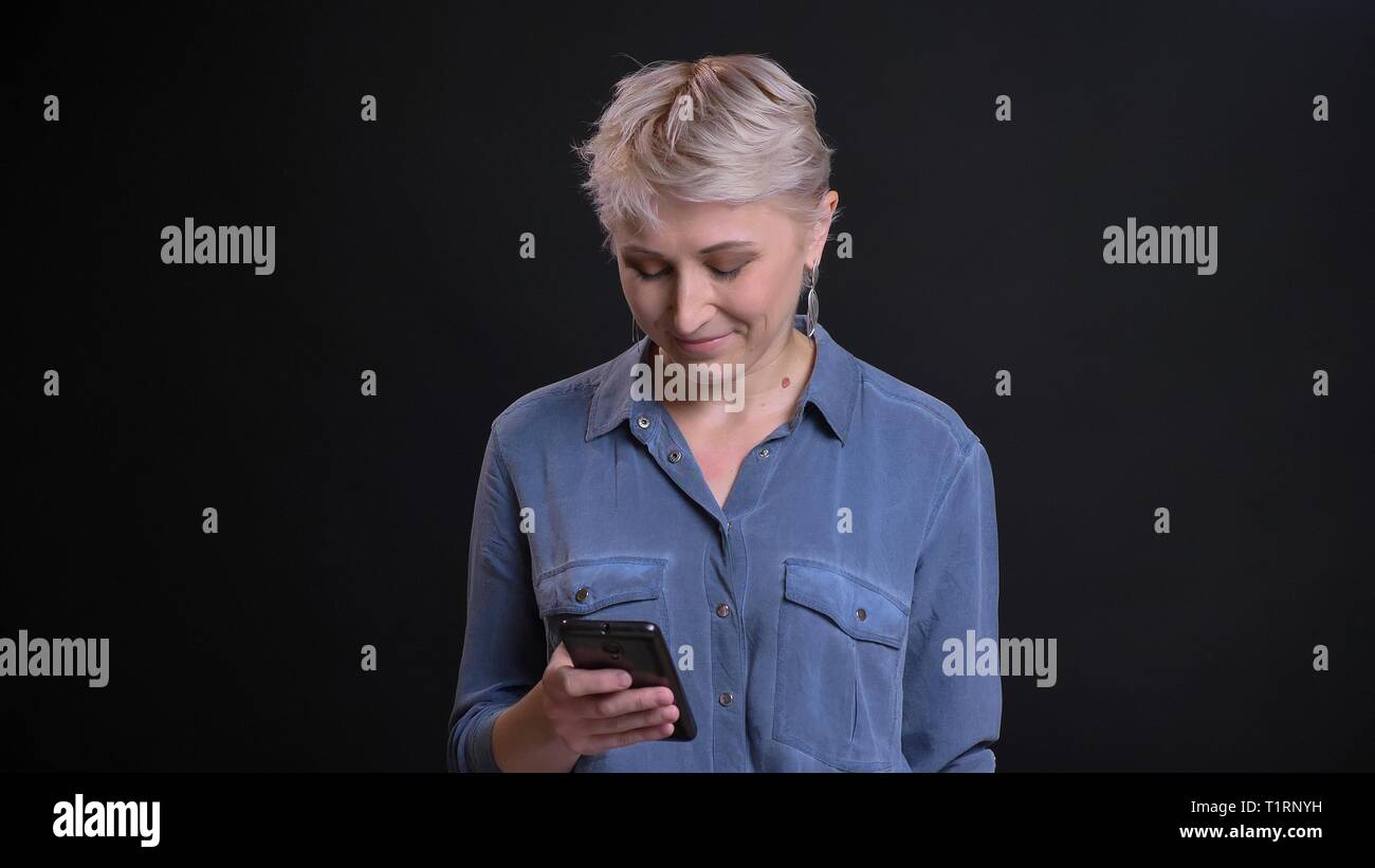 Closeup portrait of adult caucasian female with short blonde hair ...