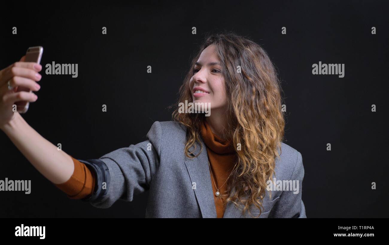 Closeup shoot of young caucasian female taking selfies on the phone and ...