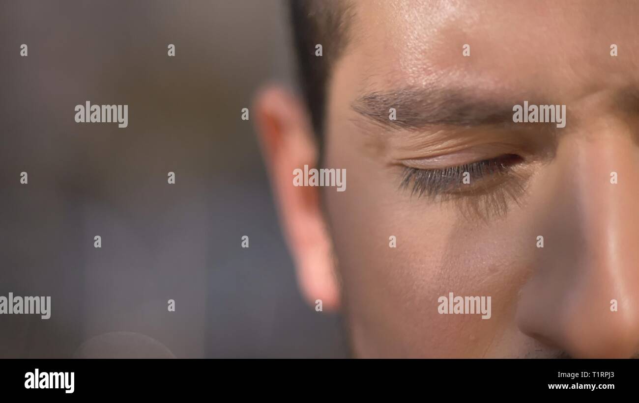 Close-up half-portrait of caucasian man with closed eyes on street ...