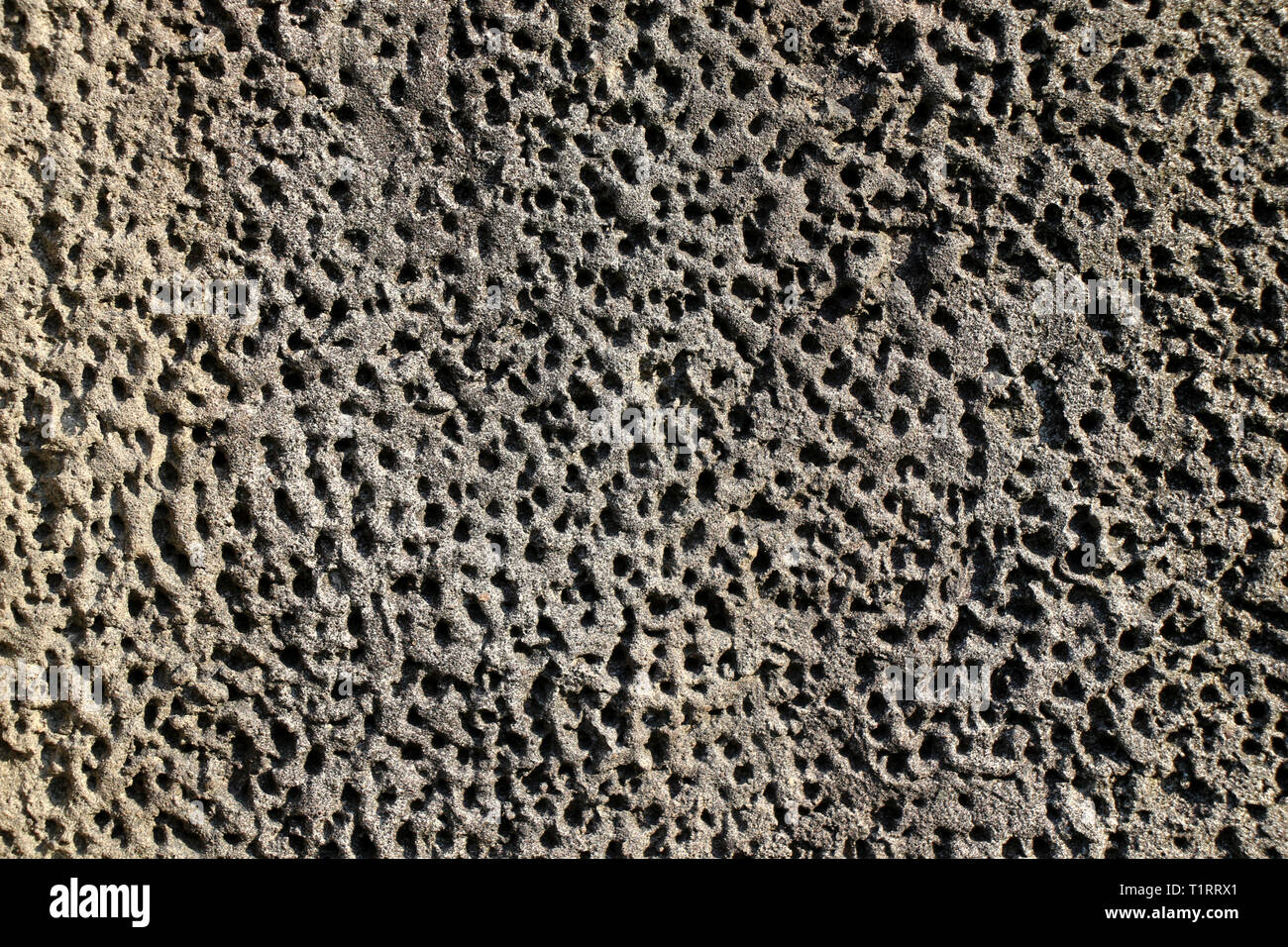 Wall made of dark color of rock Stock Photo - Alamy