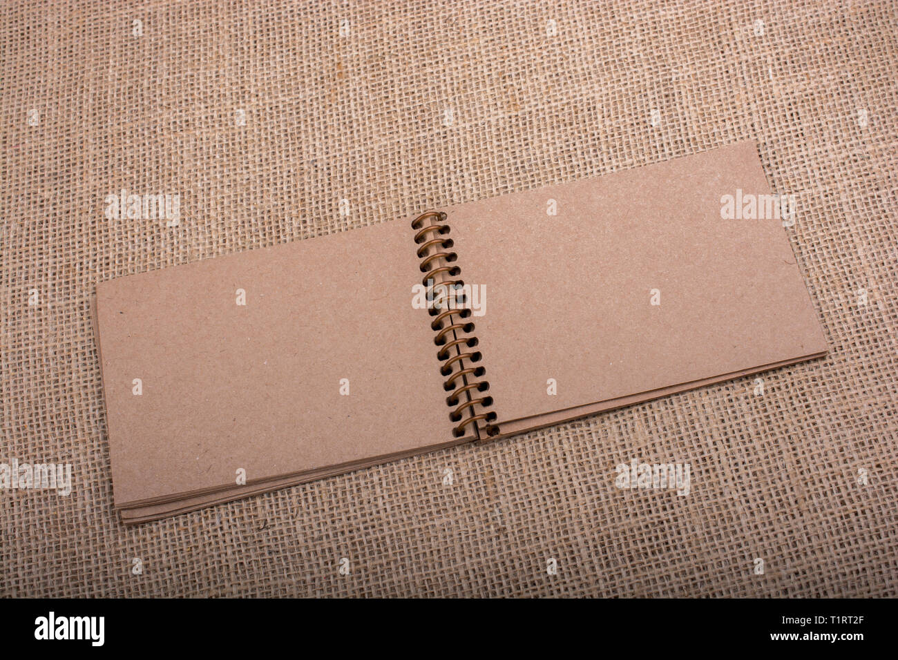 brown color notebook placed on a canvas background Stock Photo - Alamy