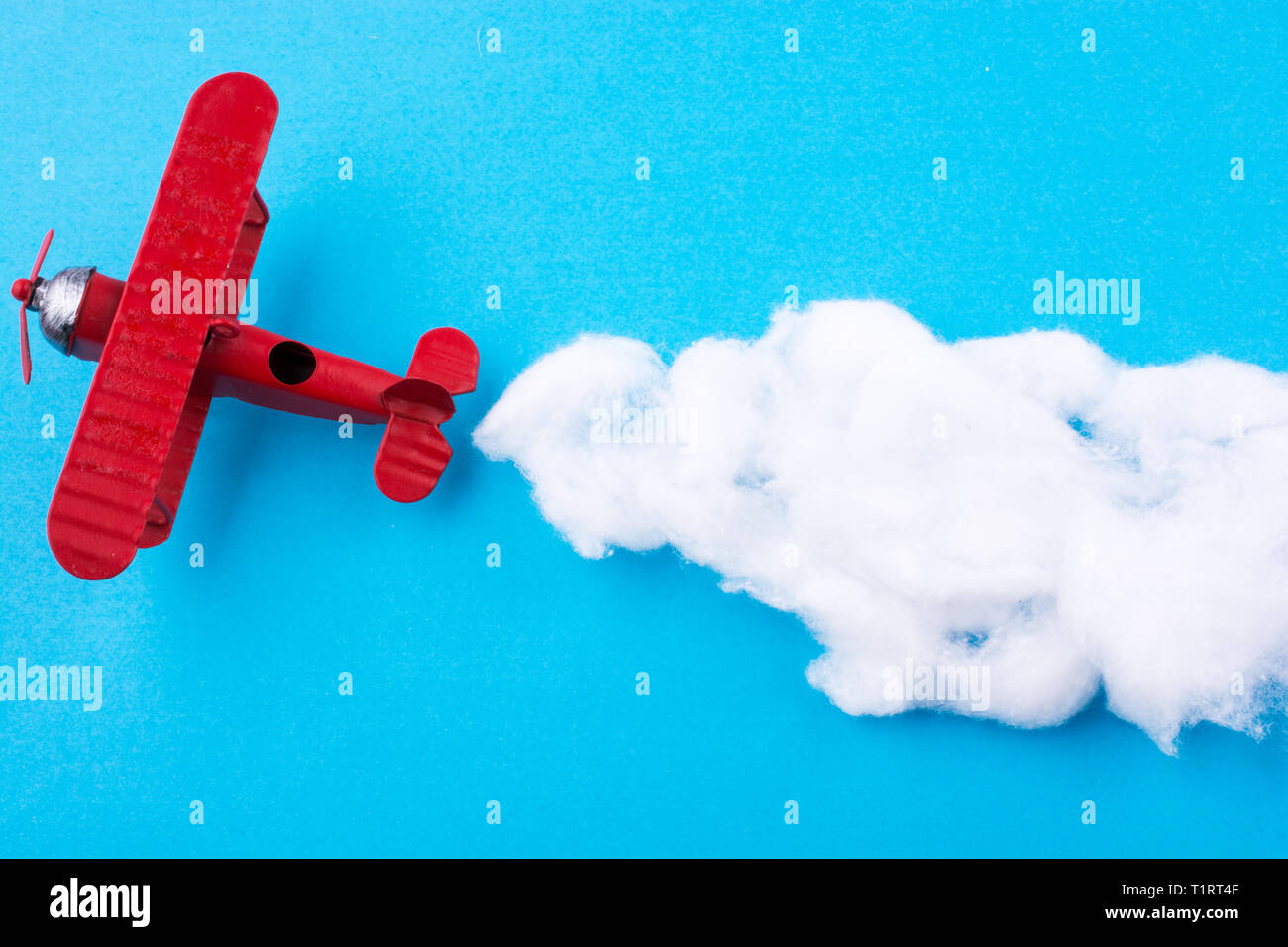 Retro styled little red model airplane in sky Stock Photo - Alamy