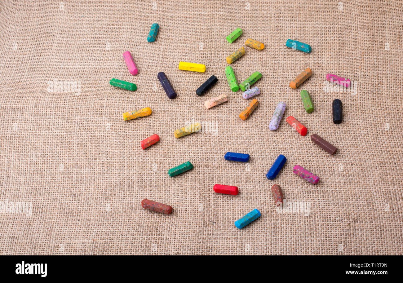 Used crayons of various color on a canvas Stock Photo - Alamy