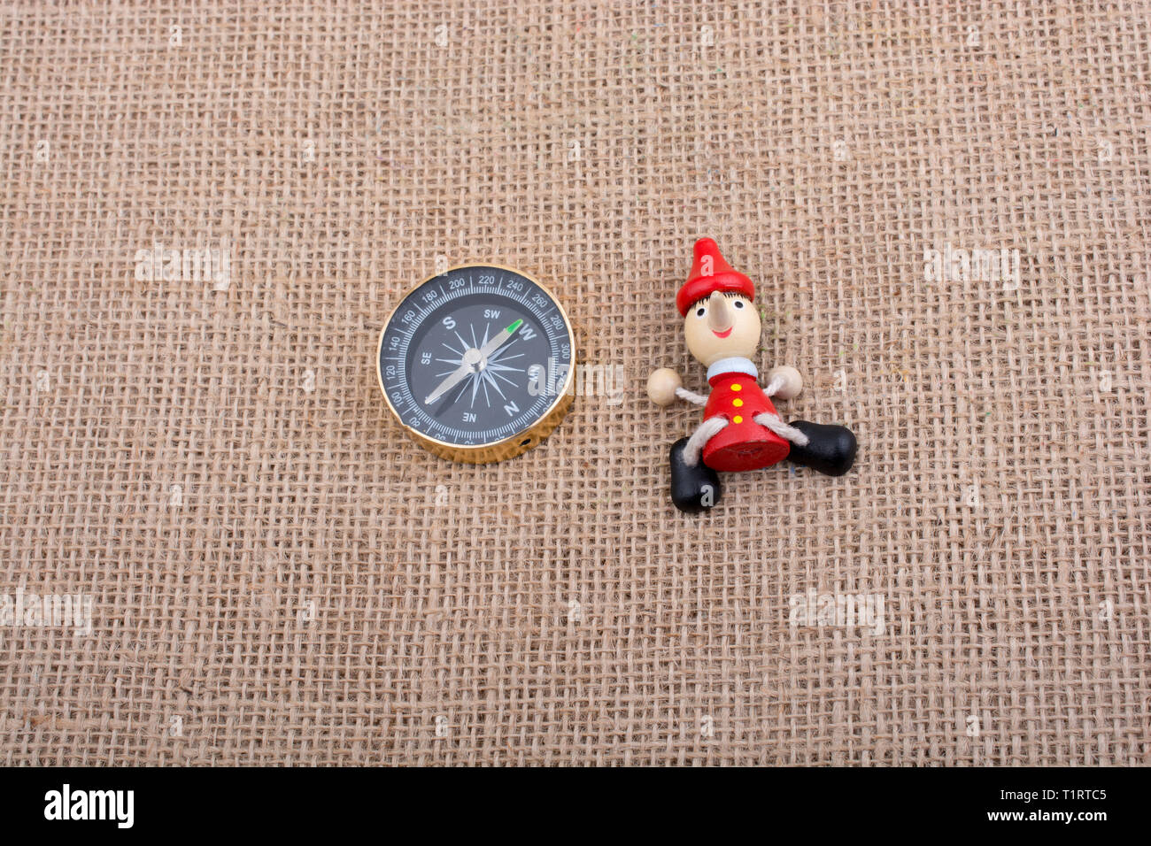Figurine of pinocchio by the side of a compass Stock Photo - Alamy