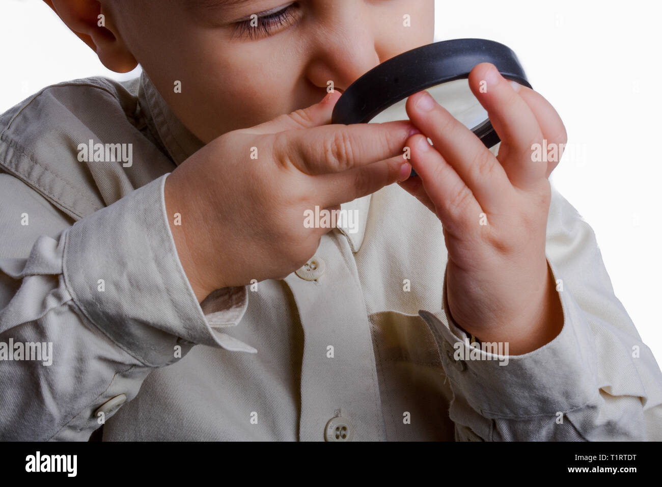 Baby holding a magnifying glass in hand on a white background Stock ...