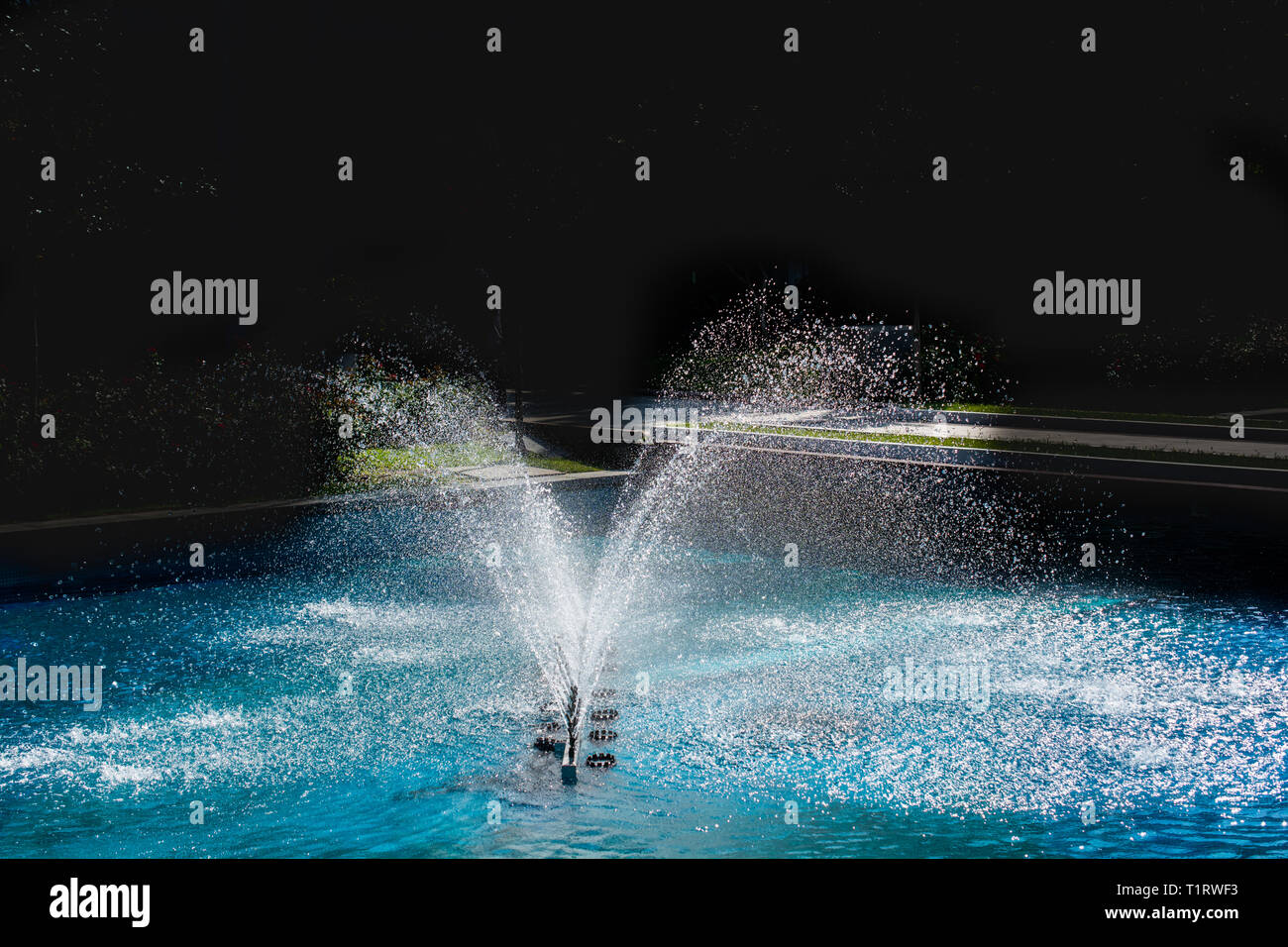 A water fountain sprinkling water in the view Stock Photo - Alamy
