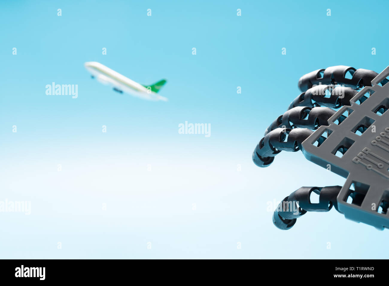 robotic hand reaching a flying aircraft concept of AI controlls the ...