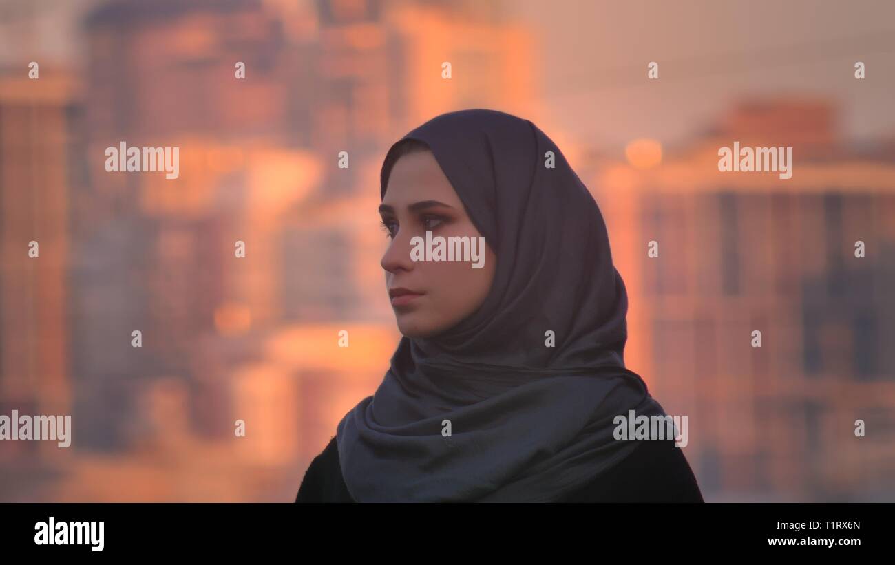 Closeup side view portrait of young attractive female in hijab looking ...