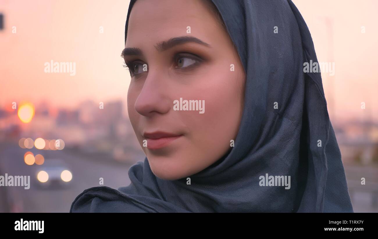 Closeup side view portrait of young attractive female face in hijab ...