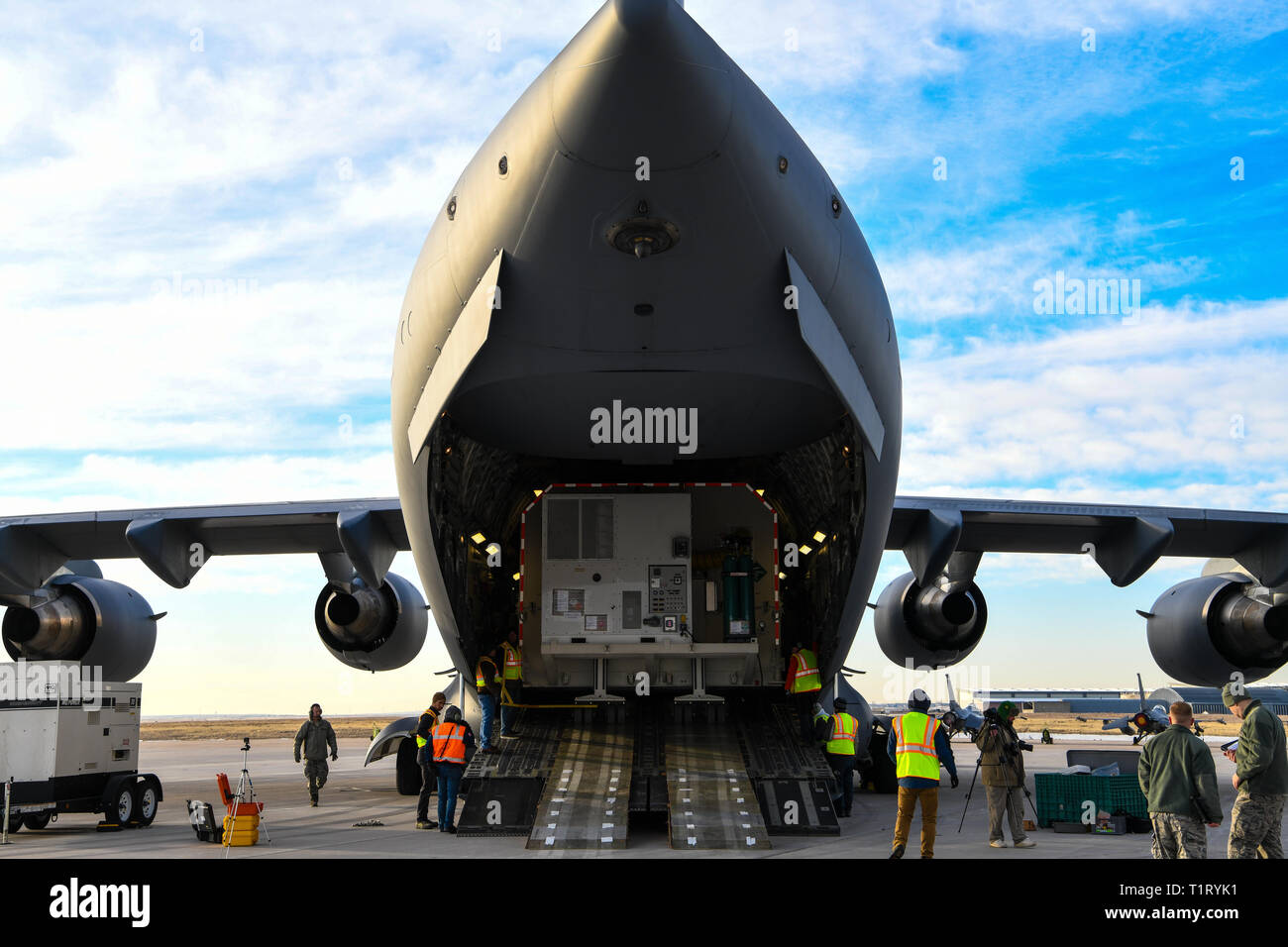 A satellite is loaded onto a C-17 Globemaster III March 19, 2018, on ...