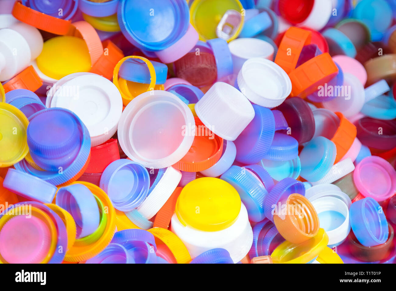 Pile of plastic bottle caps texture. A lot of bottle tops of soft ...