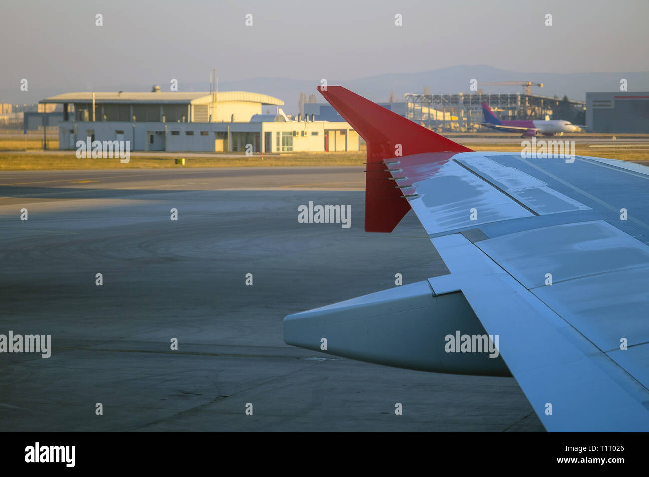 Wing of an airplane about to take of from an air port. Aircraft wing at ...