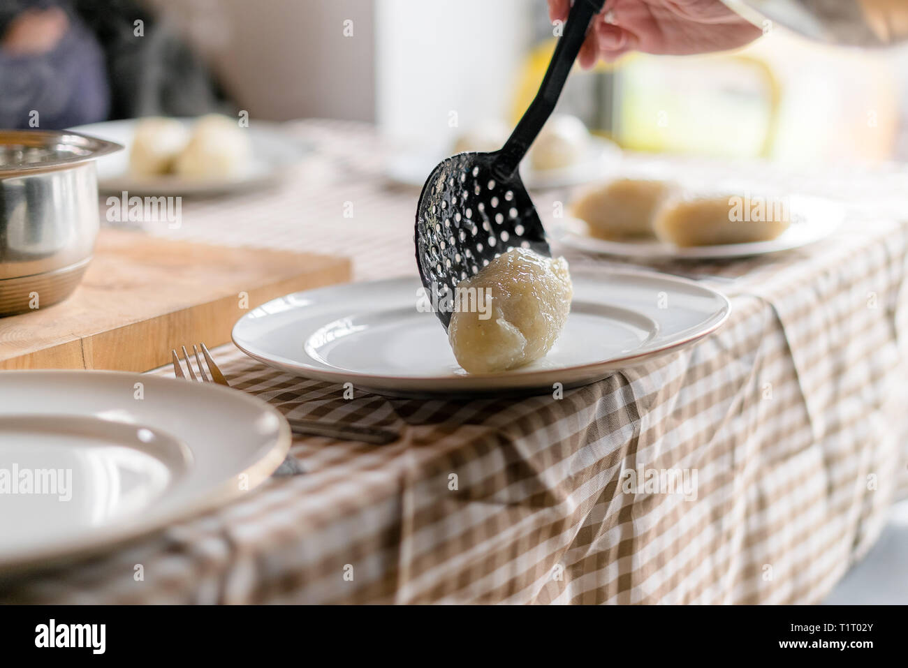 Making of Cepelinai - Zeppelins is national Lithuanian dish. Woman hand ...