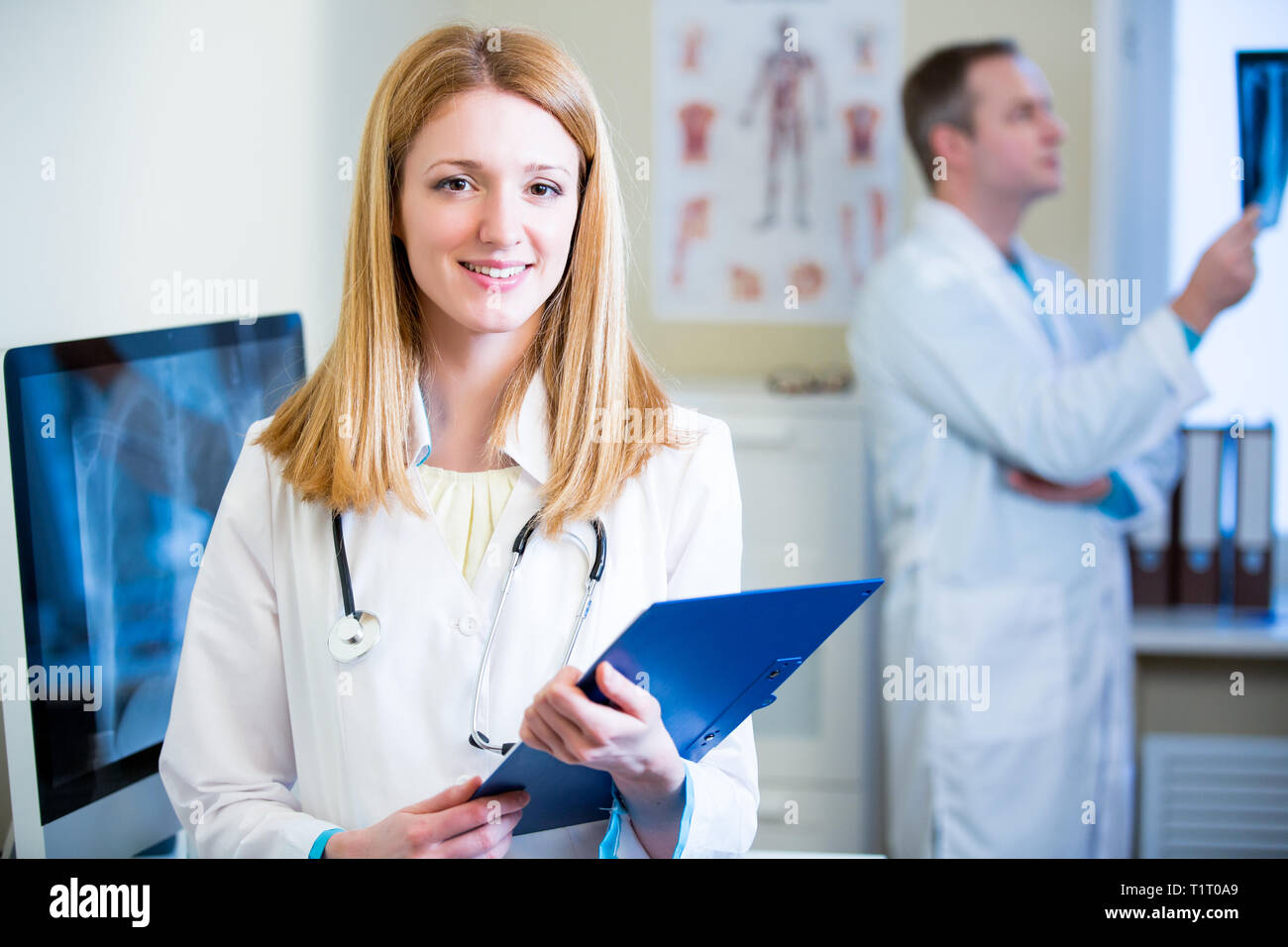 Portrait of friendly confident doctors in hospital. Enthusiastic ...