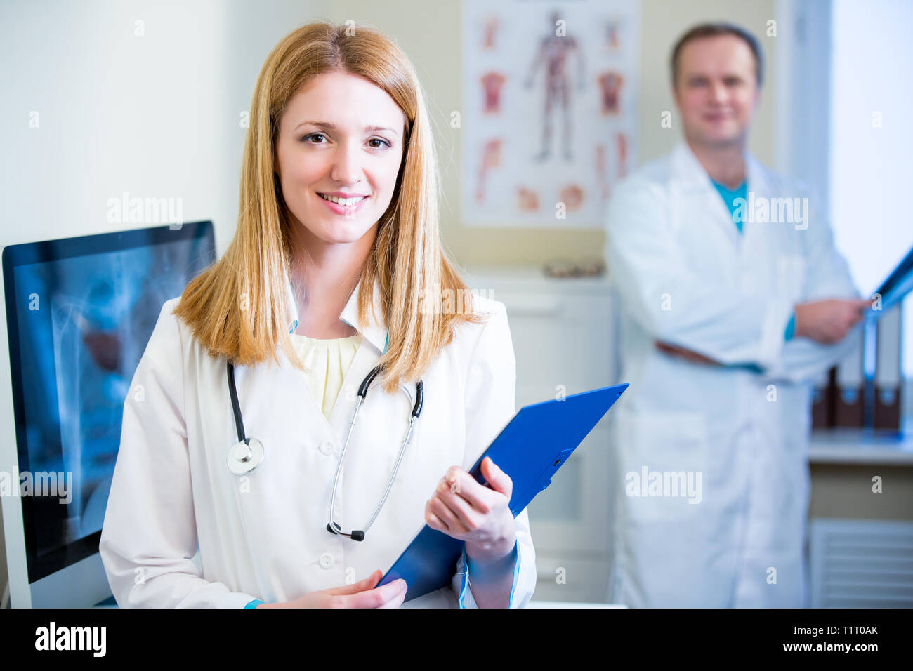 Portrait of friendly confident doctors in hospital. Enthusiastic ...