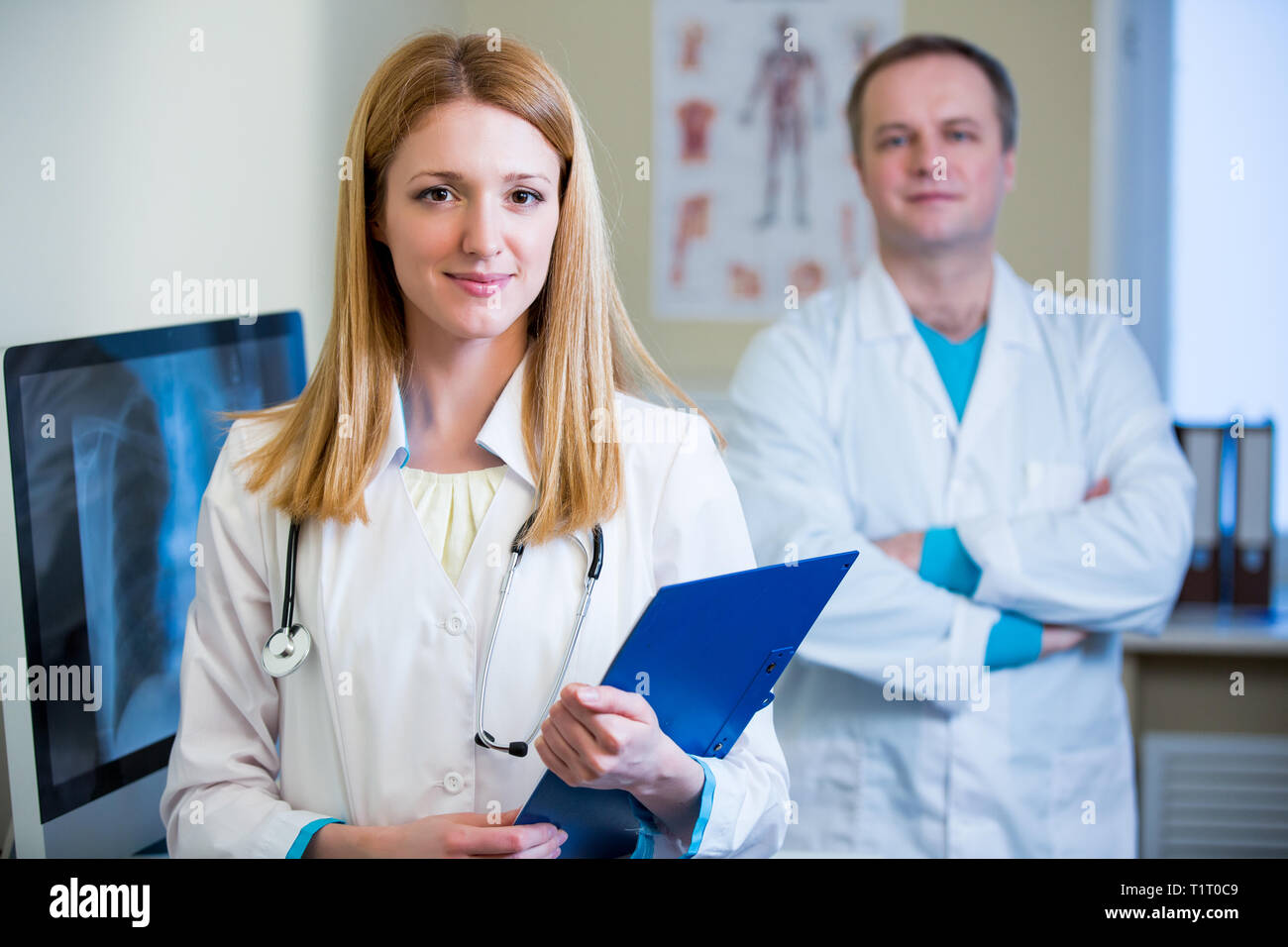 Portrait of friendly confident doctors in hospital. Enthusiastic ...