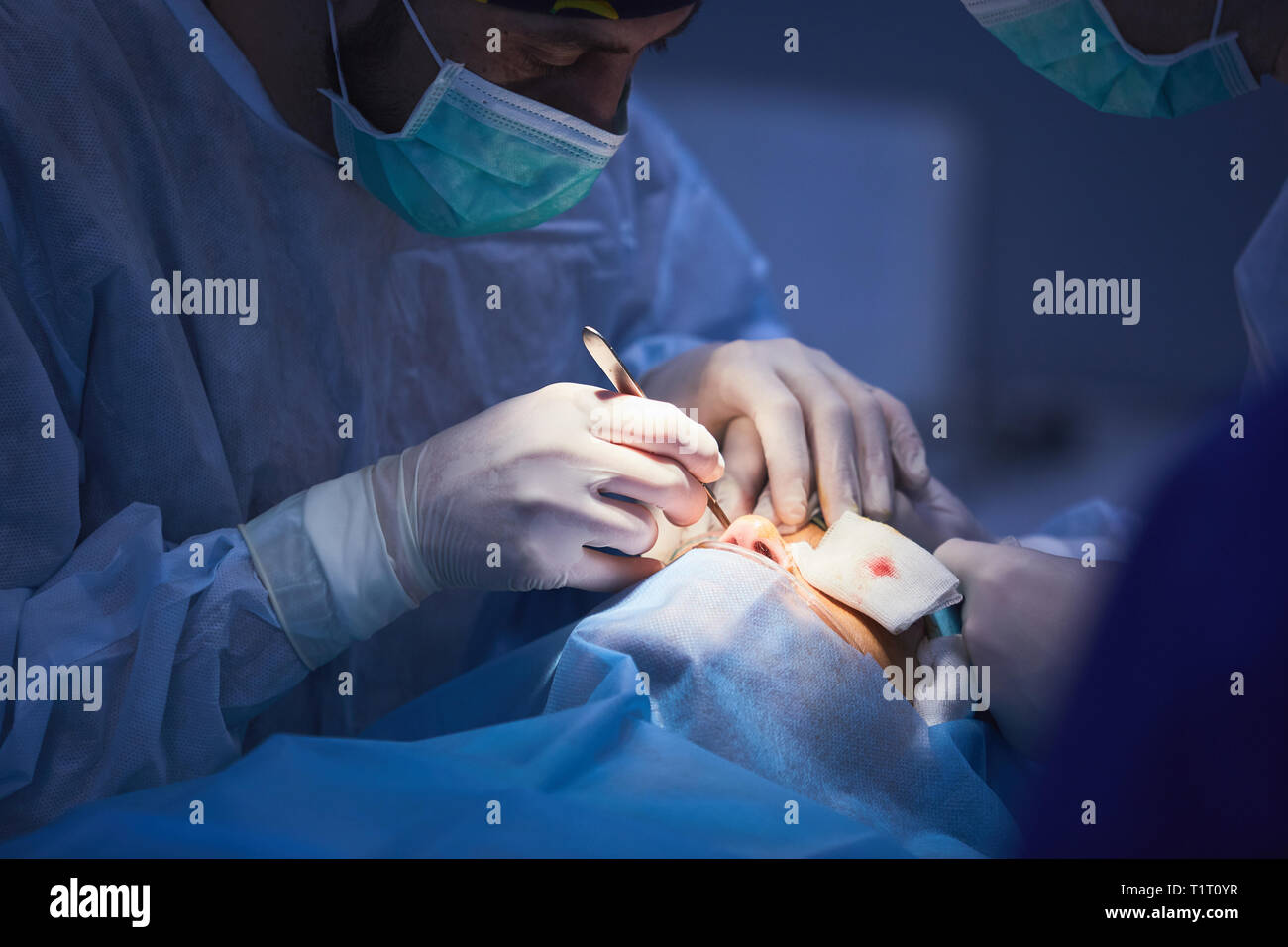 Surgical team performing surgery in modern operation theater,Team of ...