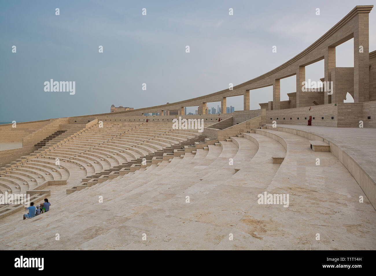 DOHA, QATAR – AUGUST 9, 2013: Lovely family sitting in the amphitheater ...