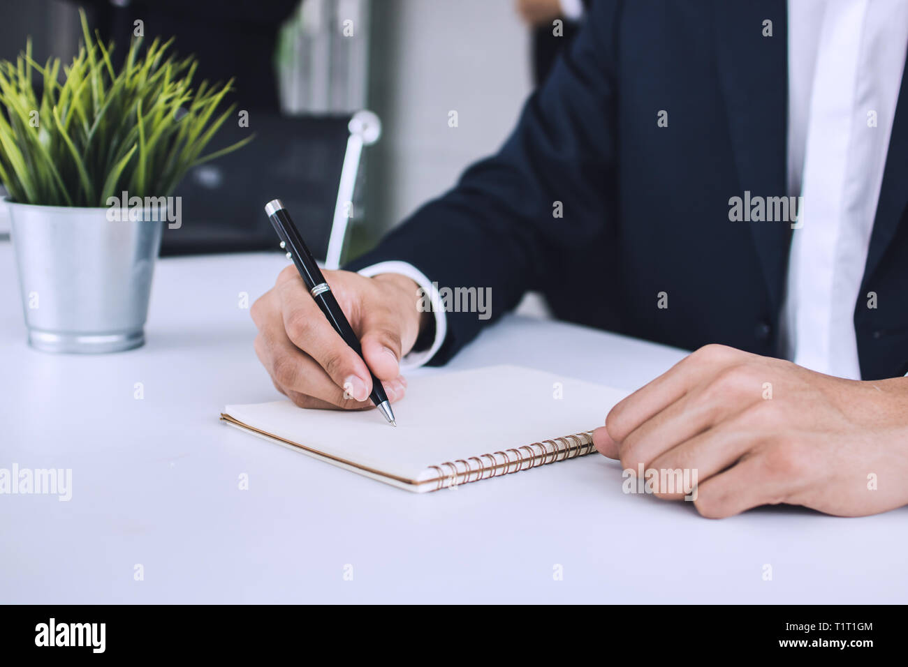 Man writing on notepad using hi-res stock photography and images - Alamy