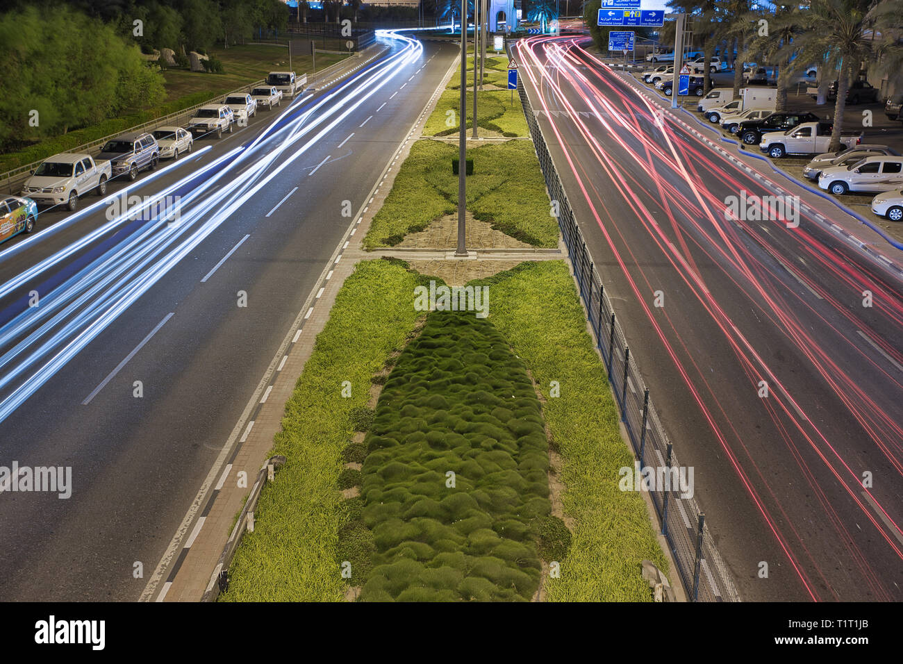 DOHA, QATAR - AUGUST 27, 2013: Light-trails of cars passing under the ...