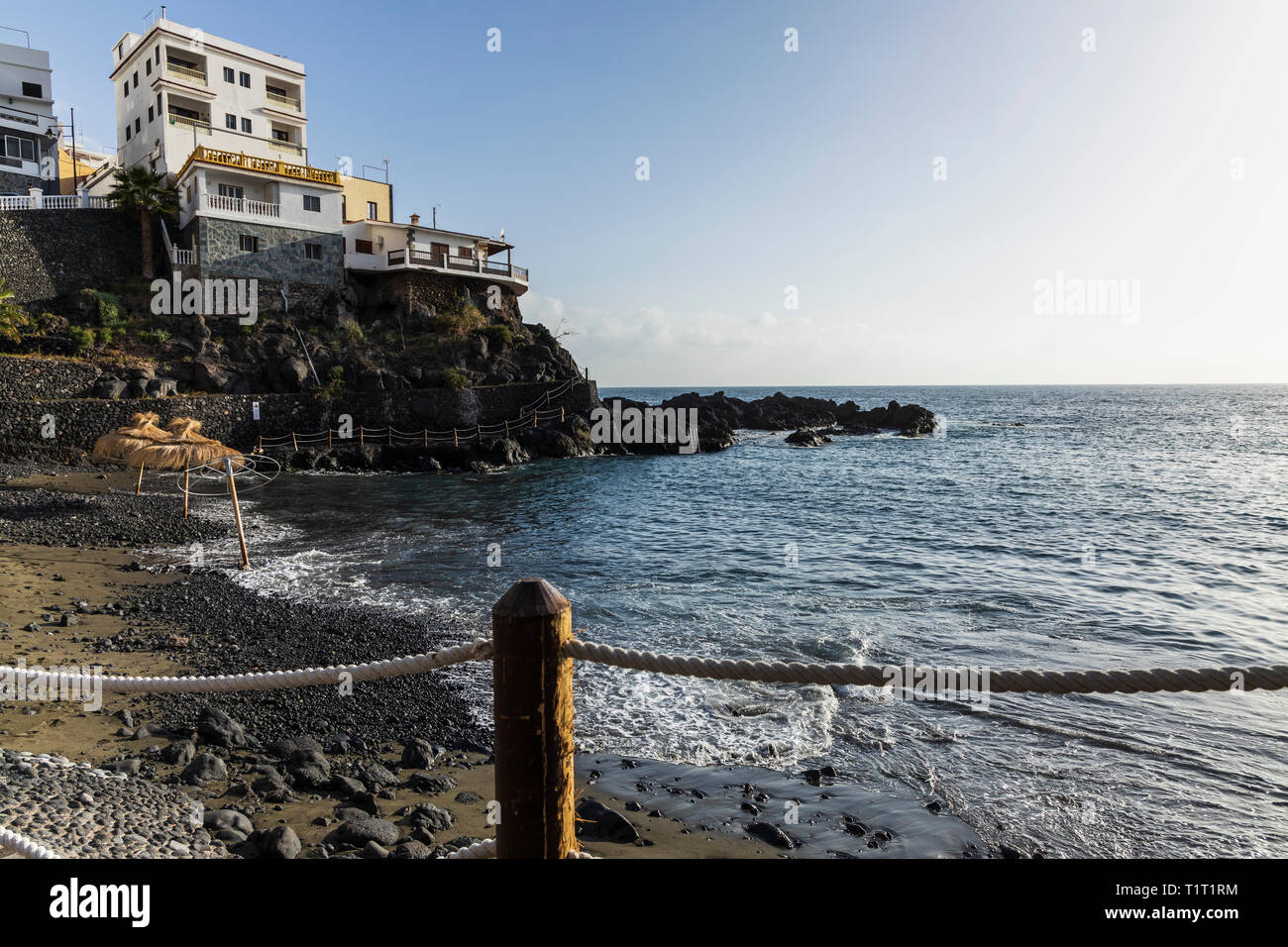 Village of Puerto Santiago above the small stony beach of Playa Chica ...