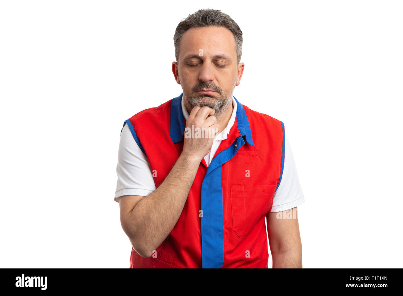 Sleepy male supermarket or hypermarket employee supporting head with ...