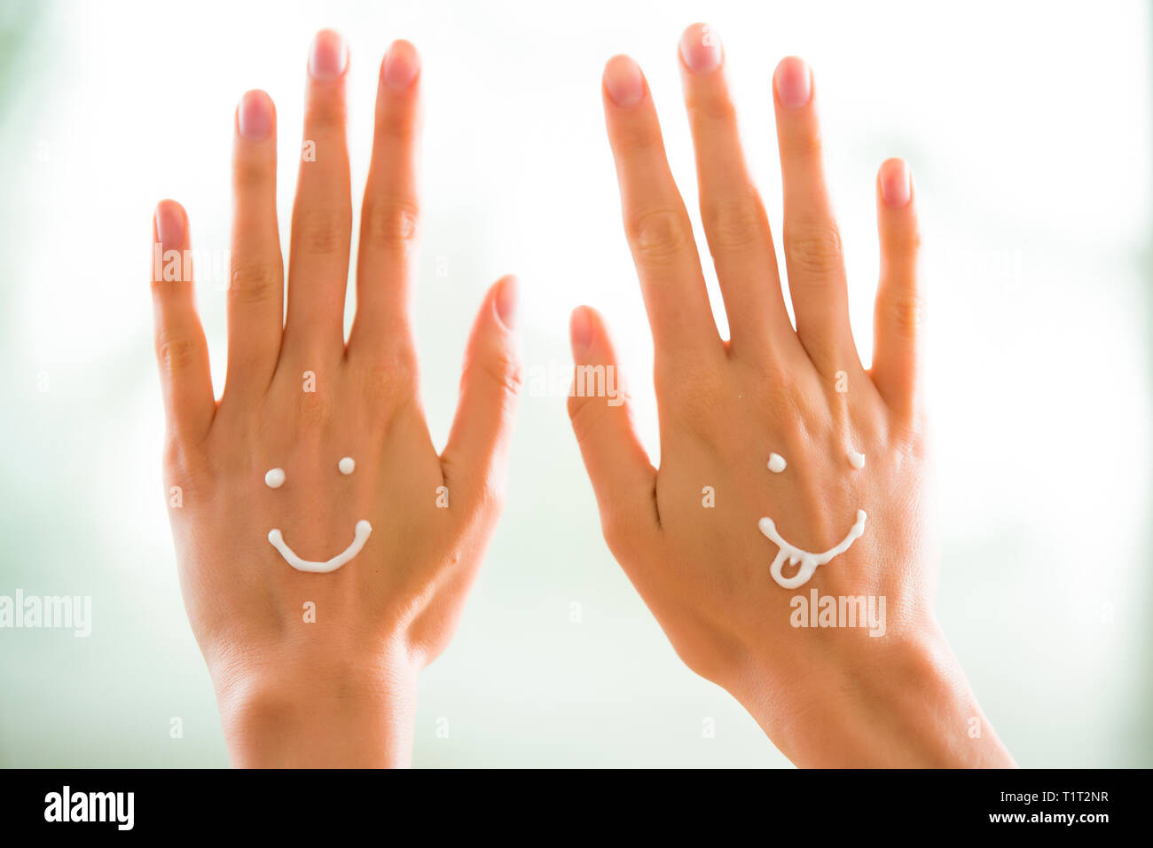 Closeup woman beautiful hands with long fingers applying moisturising ...