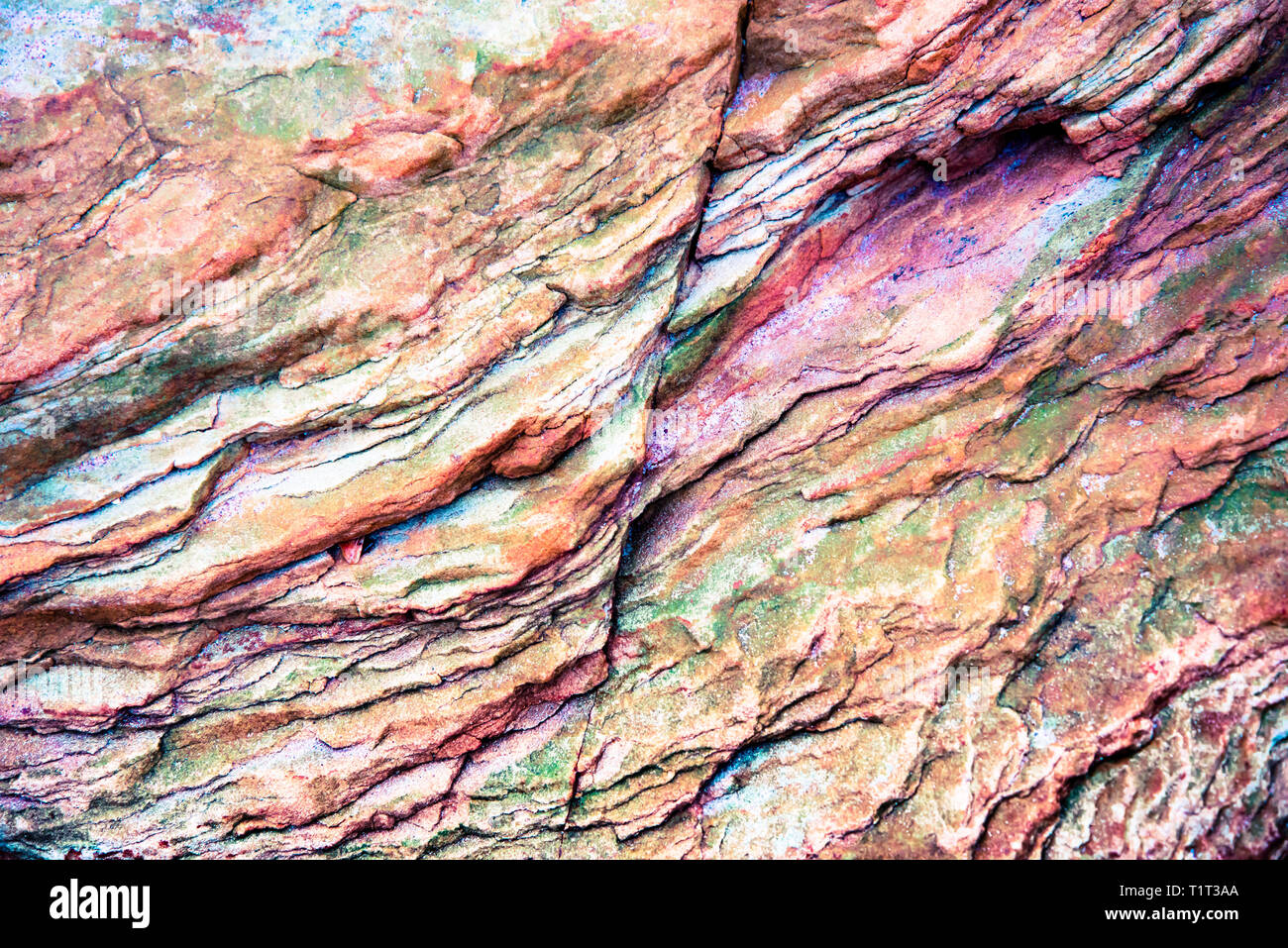 Green, orange, yellow sediments and minerals, rock formations - a ...