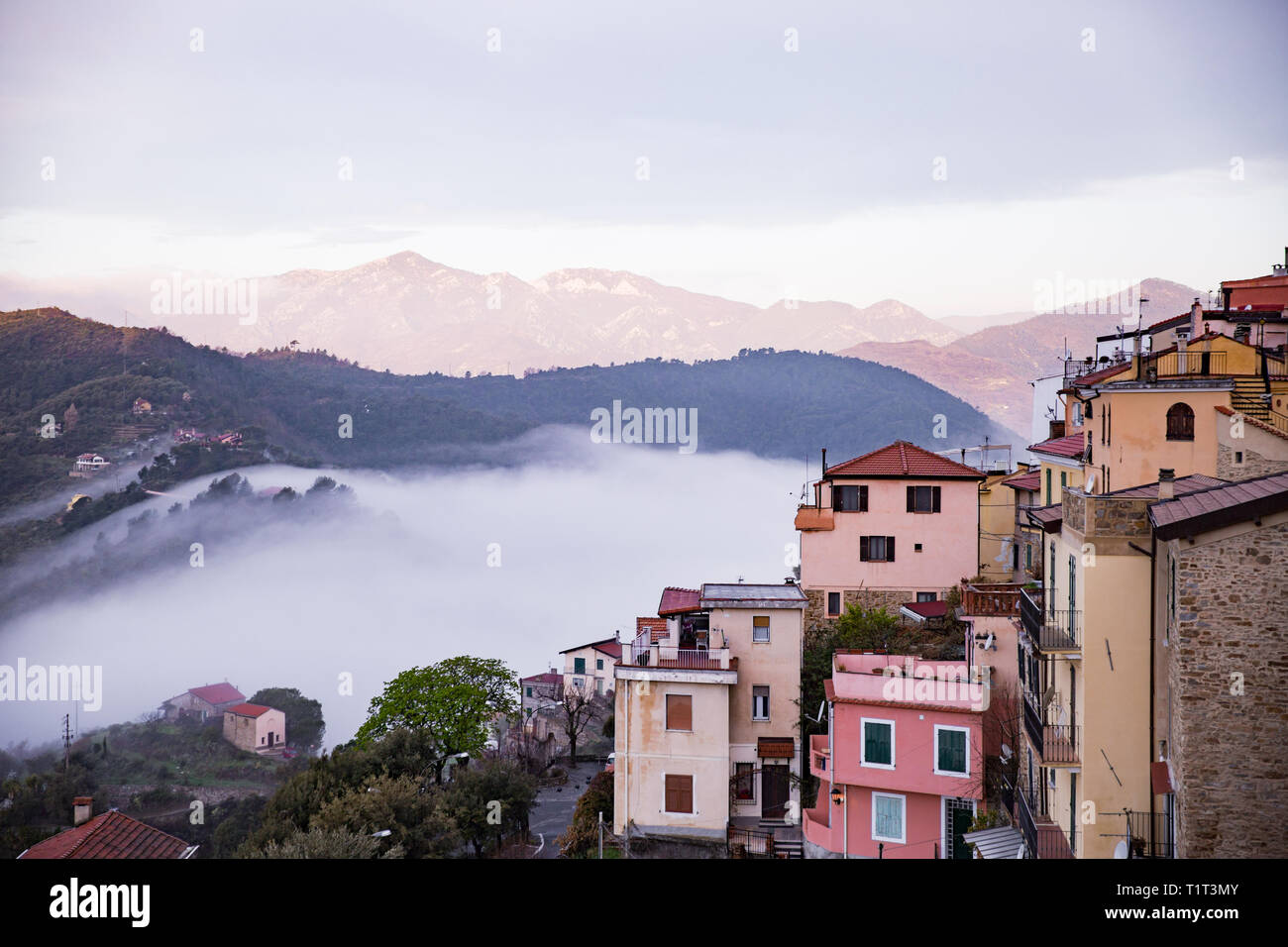 Panoramic top view of Alps mountains in fog and clouds, valley in ...