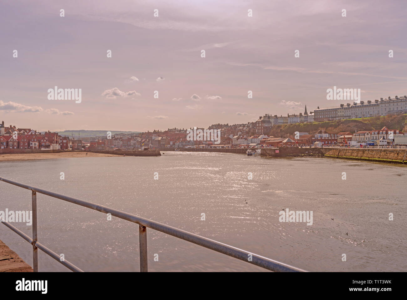Whitby harbour and town looking inwards. The town’s buildings stack ...