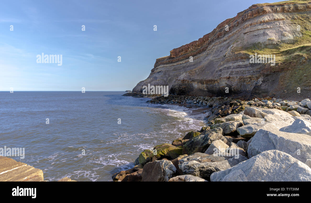 A cliff at Whitby showing its geological strata. Rocks are in the ...