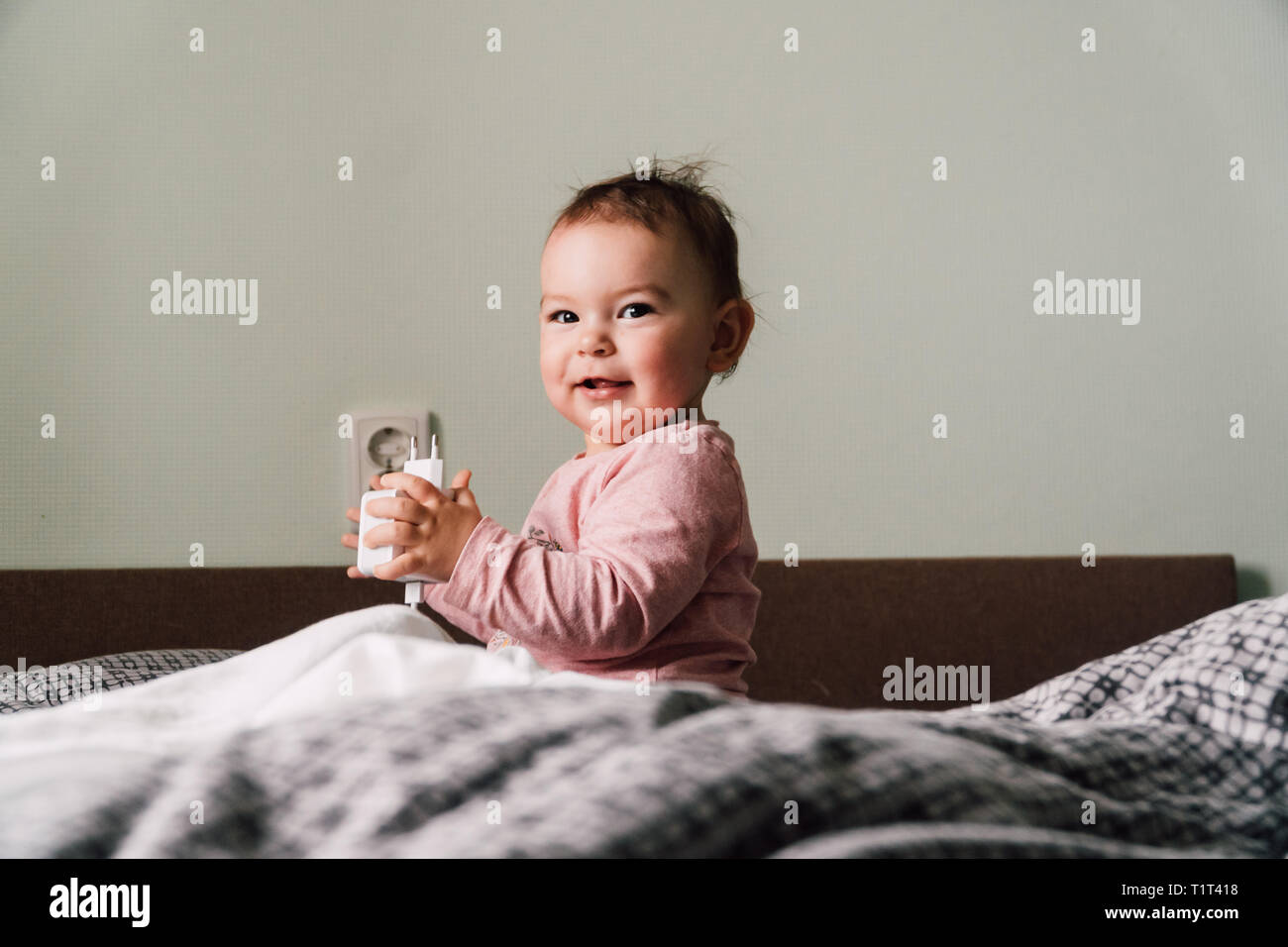 Little child's hand playing with power socket, closeup Stock Photo - Alamy
