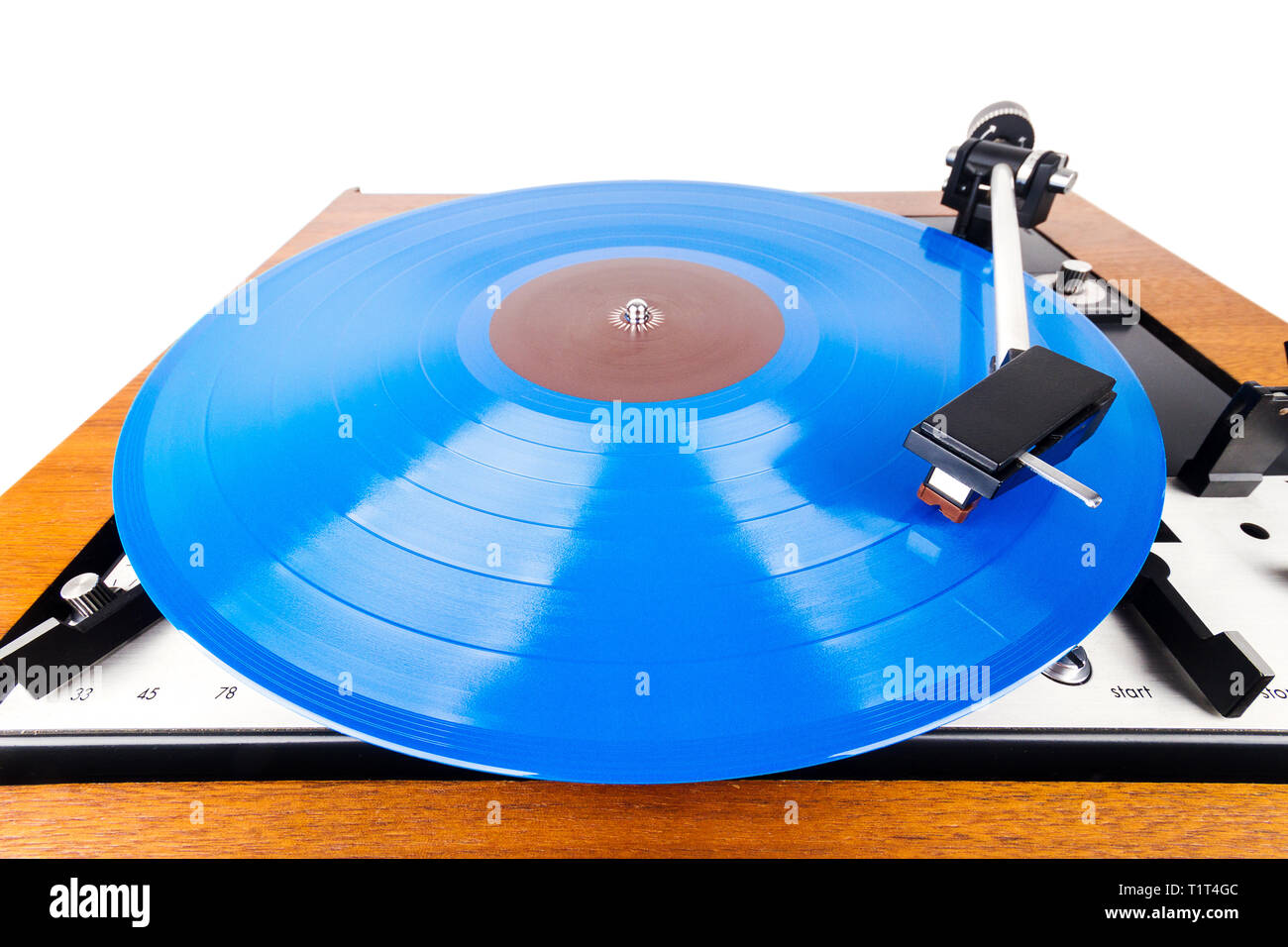 Vintage turntable with a blue vinyl isolated on white. Wooden plinth ...