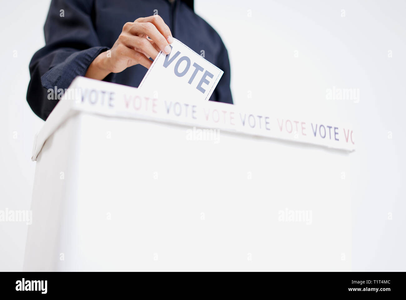 The hand putting a ballot in the ballot box Stock Photo - Alamy