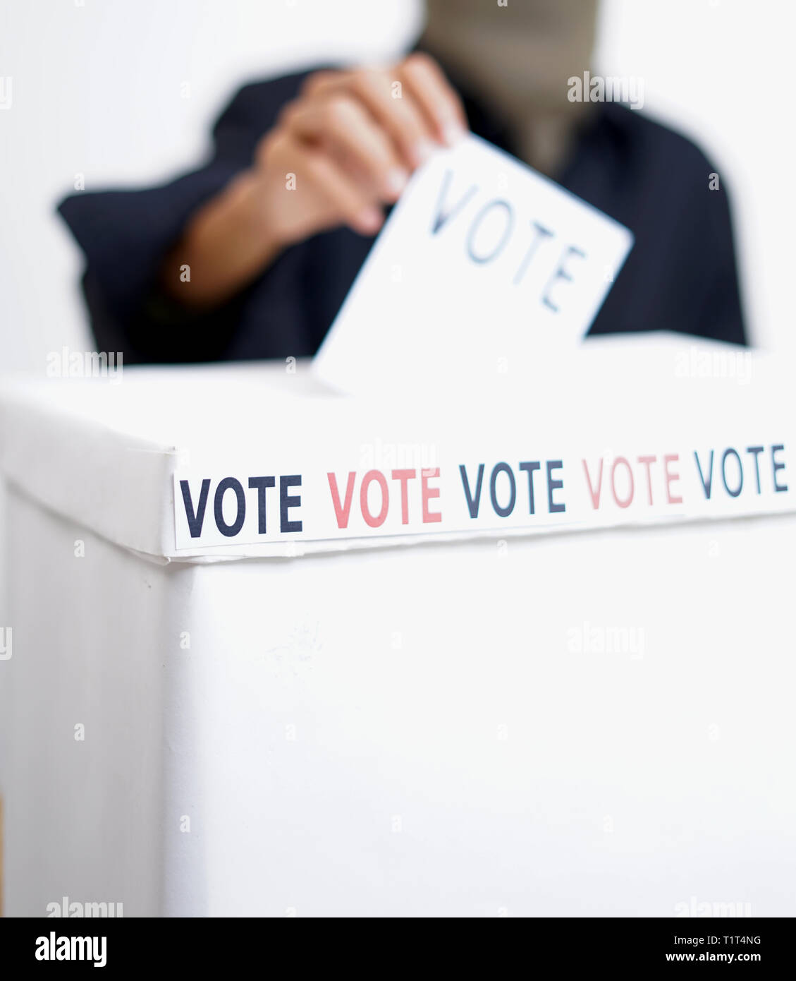 The hand putting a ballot in the ballot box Stock Photo - Alamy