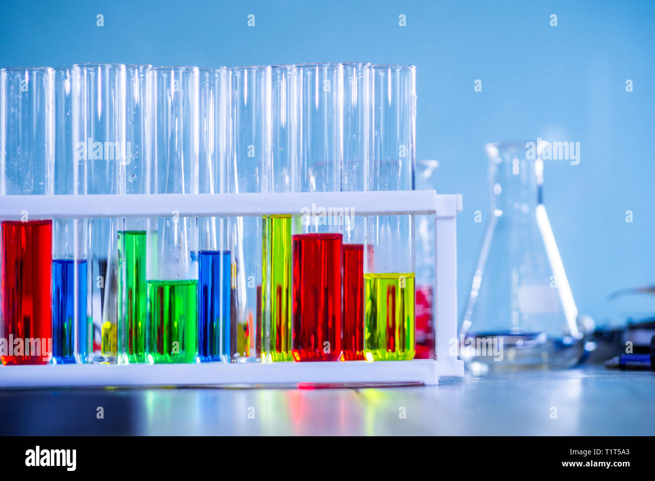 Laboratory glassware with liquids of different colors at science lab ...