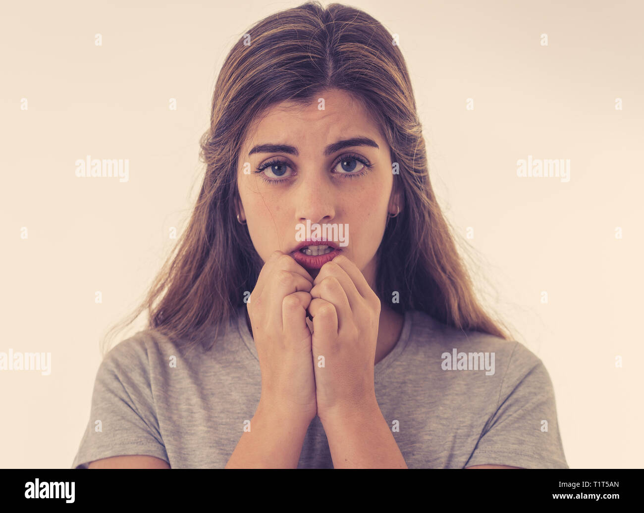 Young sad woman, serious and concerned, looking shocked and worried ...