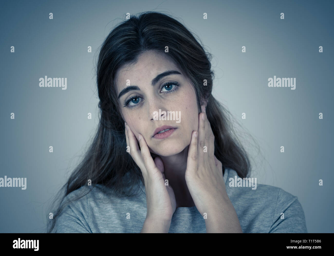 Portrait of young sad woman, serious and concerned crying and feeling ...