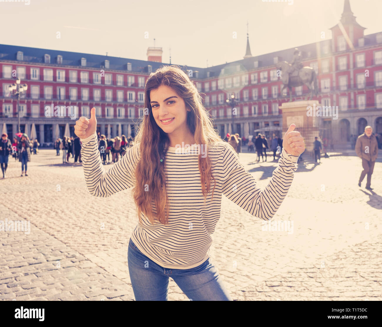 Beautiful young tourist woman happy and excited in Plaza Mayor Madrid ...