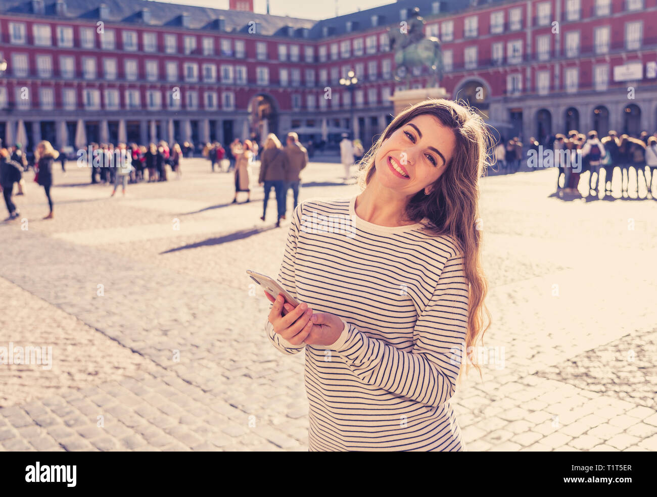 Beautiful young student tourist woman happy and excited in Plaza Mayor ...