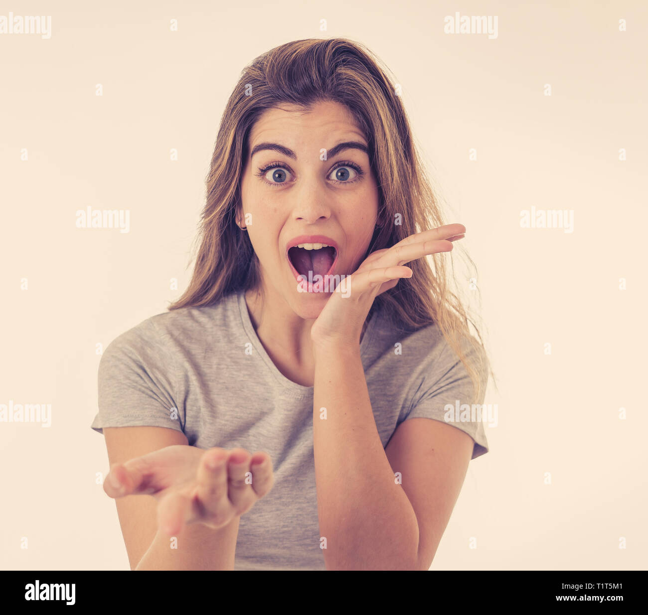 Beautiful young blond woman with happy face pointing and making ...