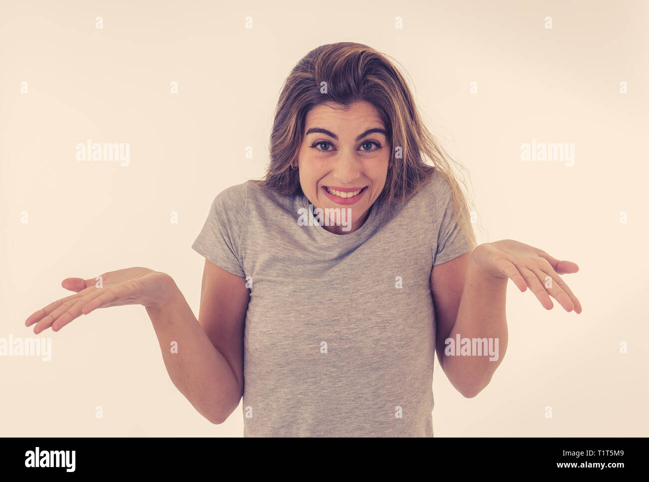 Beautiful young blond woman with happy face pointing and making ...