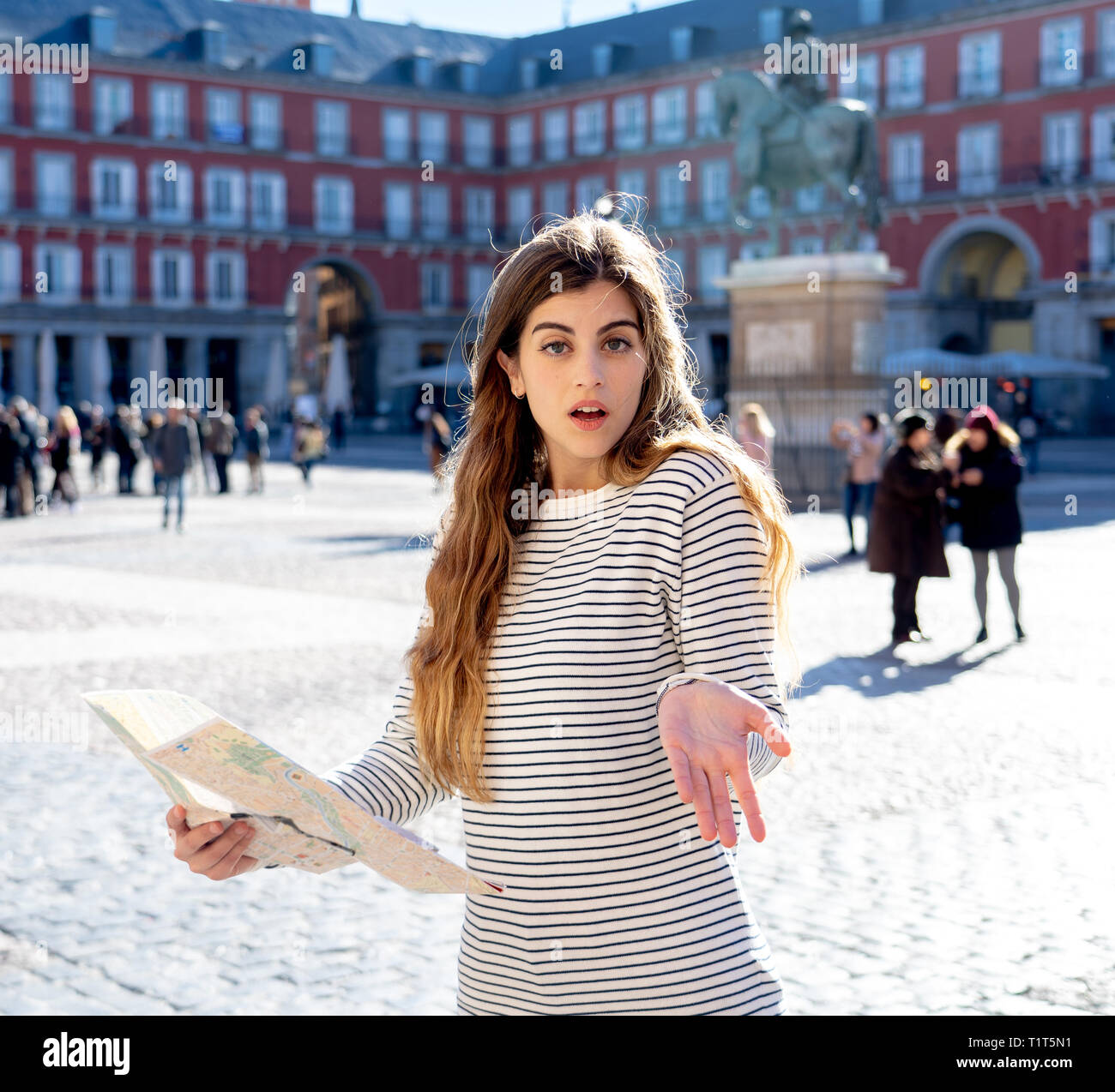 Lost young tourist trying to read a map for finding directions. Looking ...
