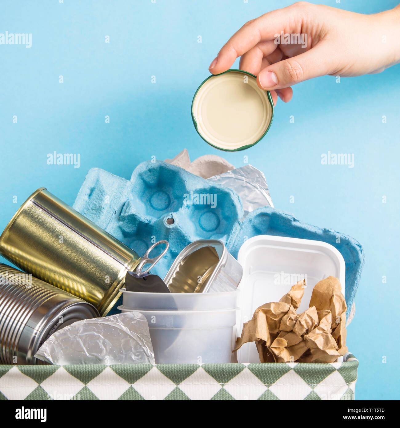 Sorting garbage for processing at home - basket on a blue background ...