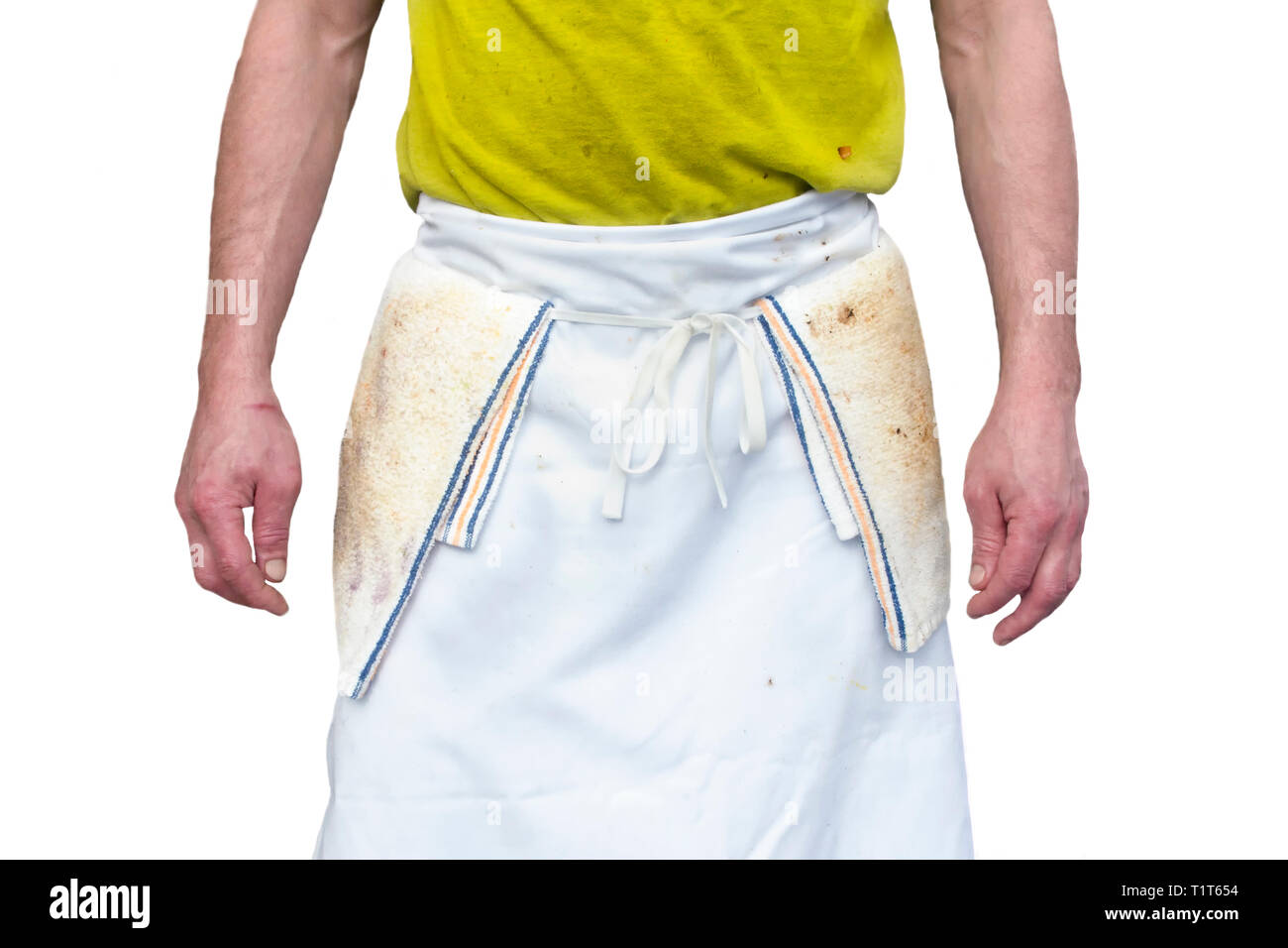 A chef wearing a dirty white apron standing outside of his diner ...