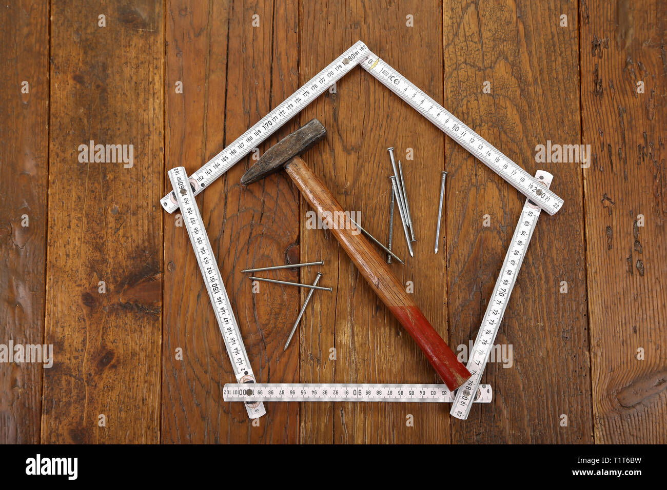 Compositions with a wooden construction meter Stock Photo - Alamy