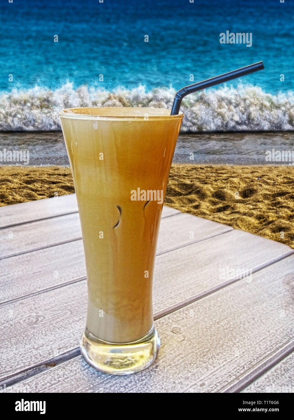 greek cold coffee called frape or cold nescafe on table with blue sea ...