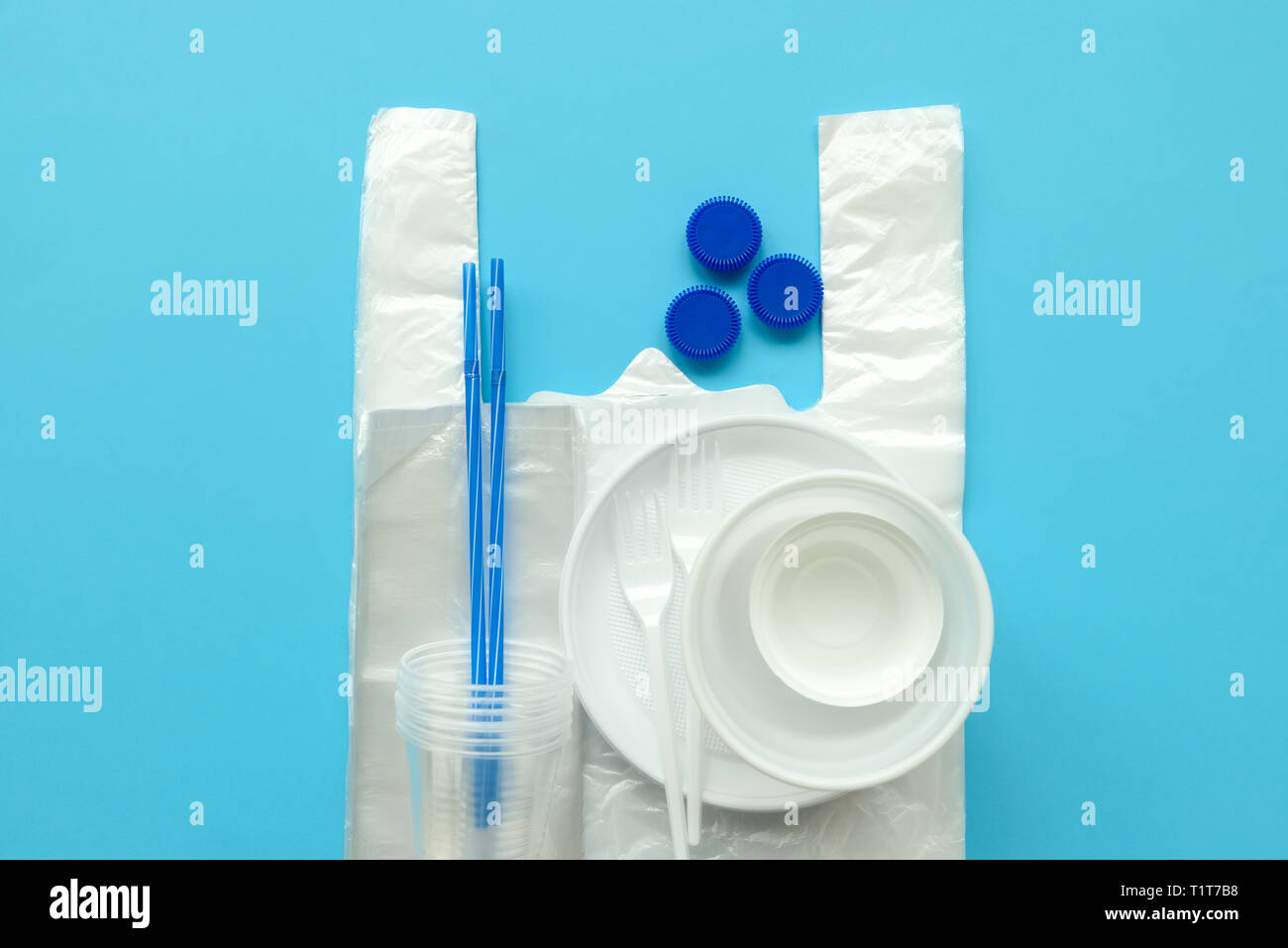 Plastic packages on blue background. Copy space. Top view. Eco and save ...